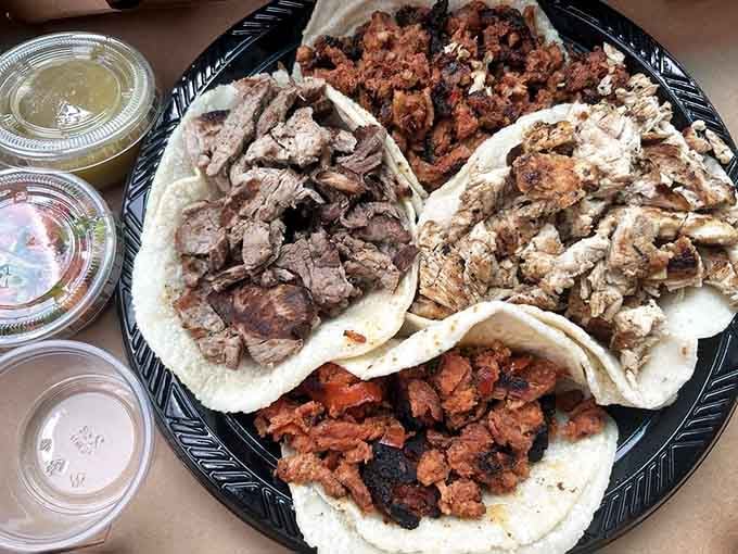 A glorious taco platter showcasing various meats on fresh tortillas, basically a greatest hits album for lunch.