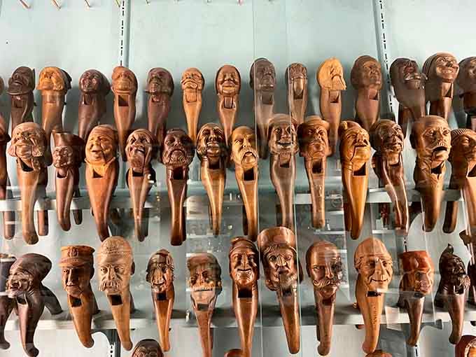 Faces carved into wooden handles create an army of expressions ranging from cheerful to mildly concerned about everything.