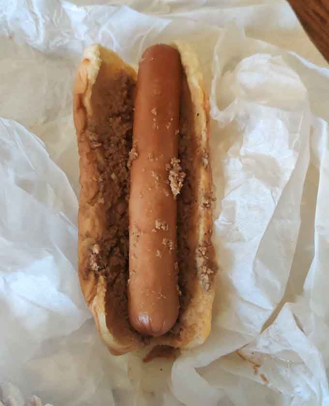 A hot dog nestled in its bun, ready to provide the savory prelude before your inevitable custard encore performance.