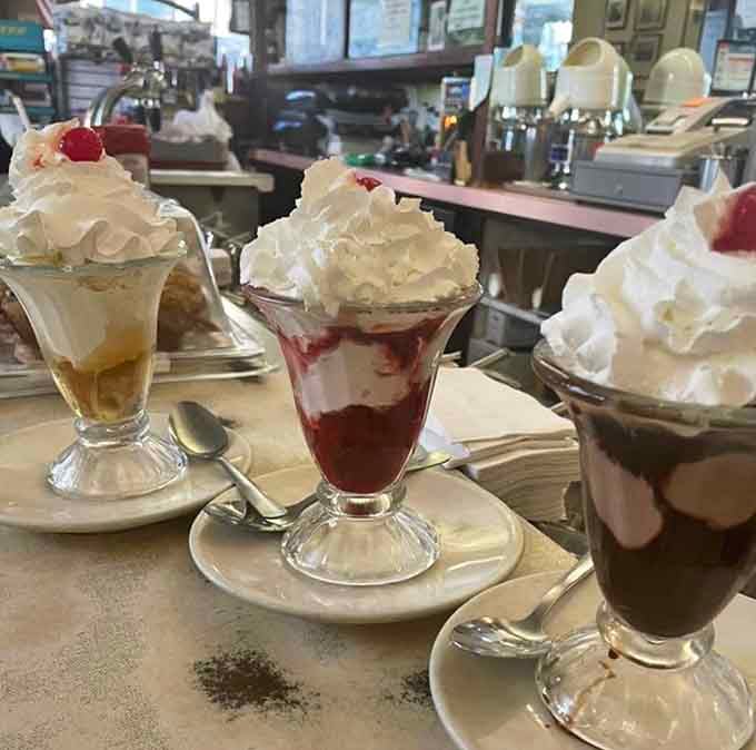 These sundaes come in vintage glassware piled high with whipped cream, proving presentation matters even for comfort food.