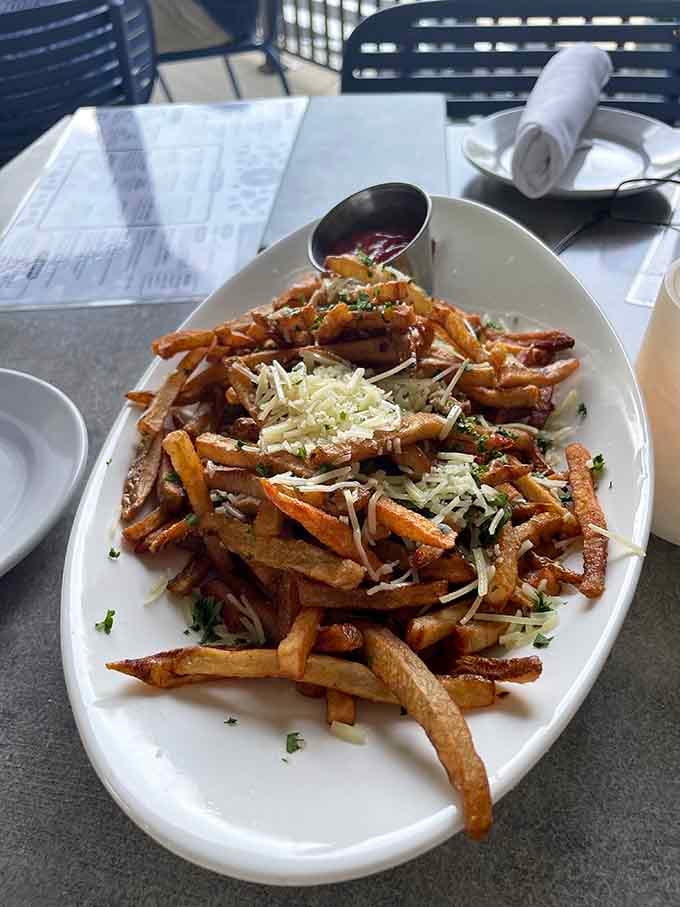 Truffle fries piled high with parmesan, proving that some side dishes deserve to be the main event.