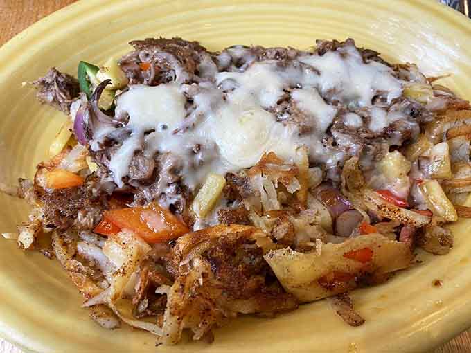 Pulled pork meets crispy potatoes under a blanket of melted cheese, creating pure breakfast magic on one plate.