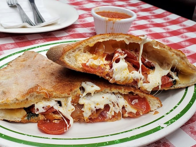 That cheese pull is real, folks &ndash; calzones here don't mess around with portion sizes or flavor.