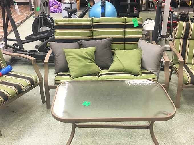 Patio furniture with striped cushions that screams summer relaxation, complete with a matching table for your lemonade and good times.