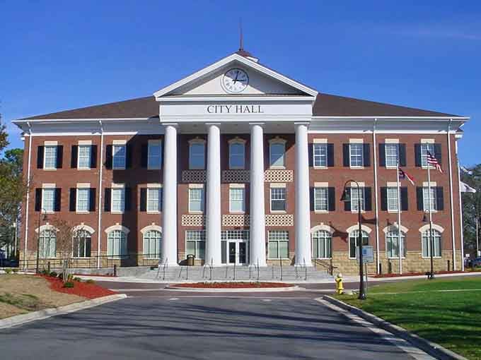City Hall stands proud with its stately columns, looking exactly like a government building should in a proper town.
