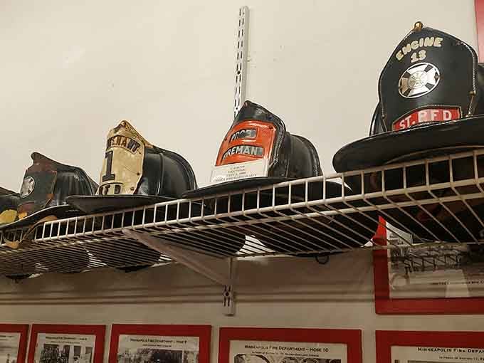 Leather helmets lined up on the shelf bear the scars and stories of countless emergency calls.