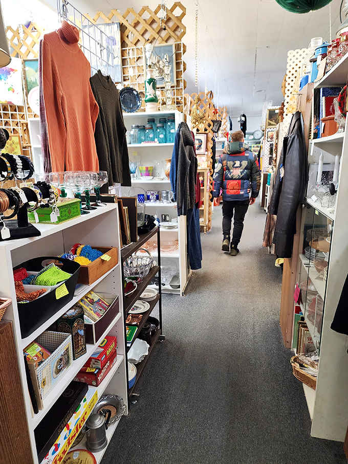 A shopper navigating aisles of vintage clothing and treasures, living proof that the best adventures happen indoors on any given Tuesday.