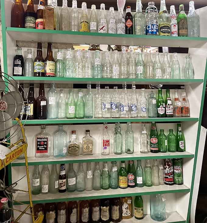 Old bottles lined up like soldiers, each one a messenger from brands and beverages long forgotten.