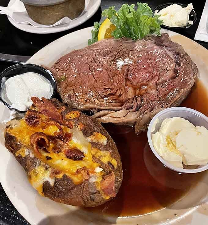 Prime rib so massive it needs its own zip code, paired with a loaded baked potato that's basically a meal.