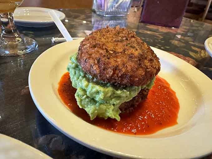 The Tenderloin Gouda Tower sits on mashed potatoes like a delicious architectural achievement you're about to happily demolish.