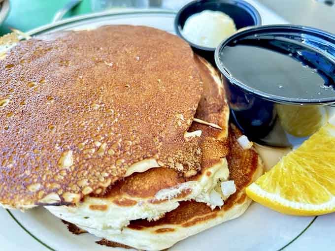 Pancakes stacked high and dusted with powdered sugar, ready to make your morning infinitely better than it was.