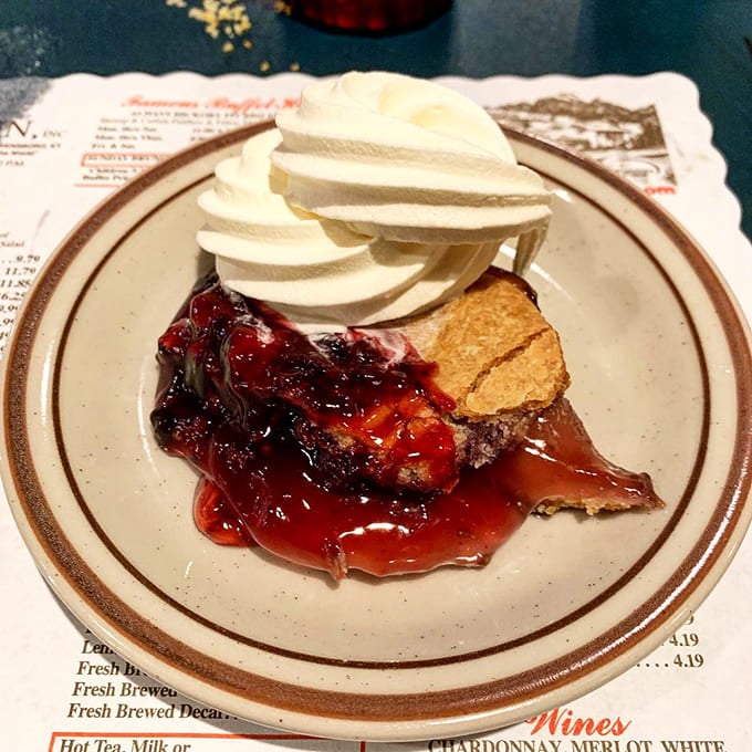 Blackberry cobbler topped with whipped cream: the dessert that makes you forget you're already impossibly full.