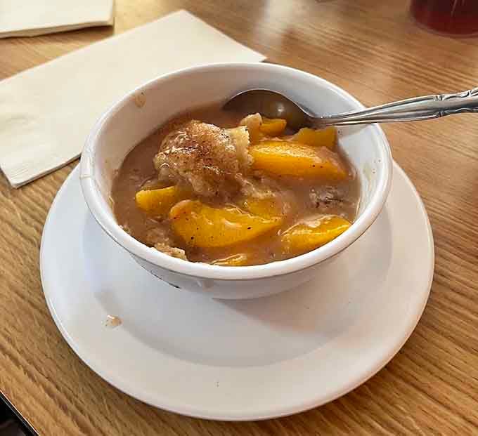 Peach cobbler that's basically summer in a bowl, warm and sweet enough to solve most life problems.