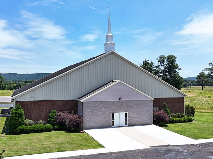 This church's steeple reaches skyward against an Alabama blue backdrop, anchoring the community in traditions that span generations.