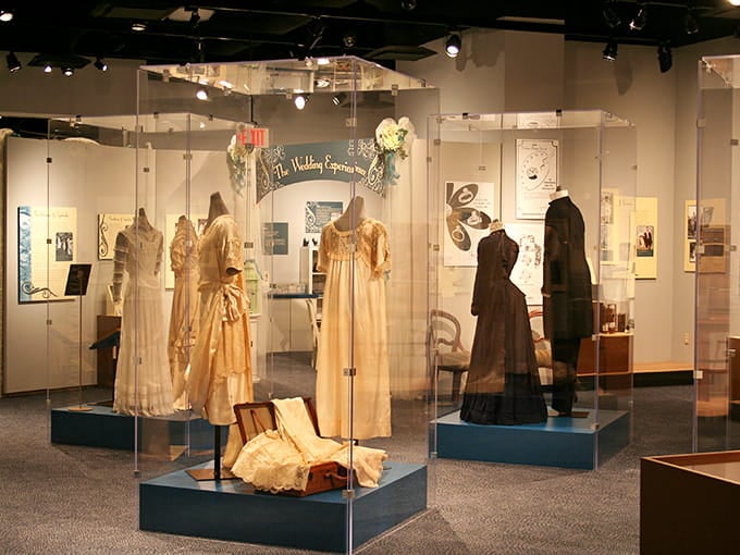 Those elegant Victorian dresses behind glass tell stories of Sunday socials and front porch gatherings in a bygone era.