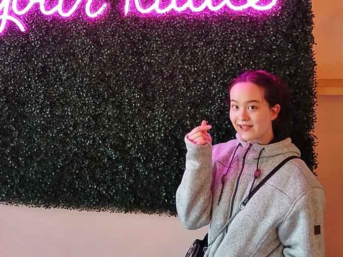 That smile says it all: this is what pure joy looks like in cat cafe form.