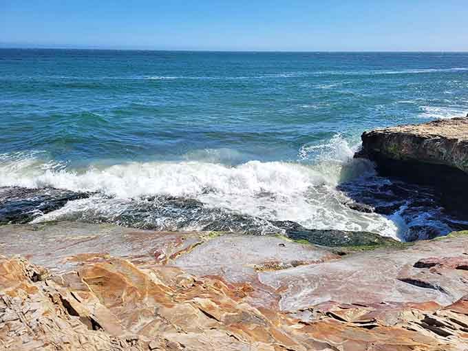 Waves crash through the opening with the kind of drama that makes you forget your phone exists.