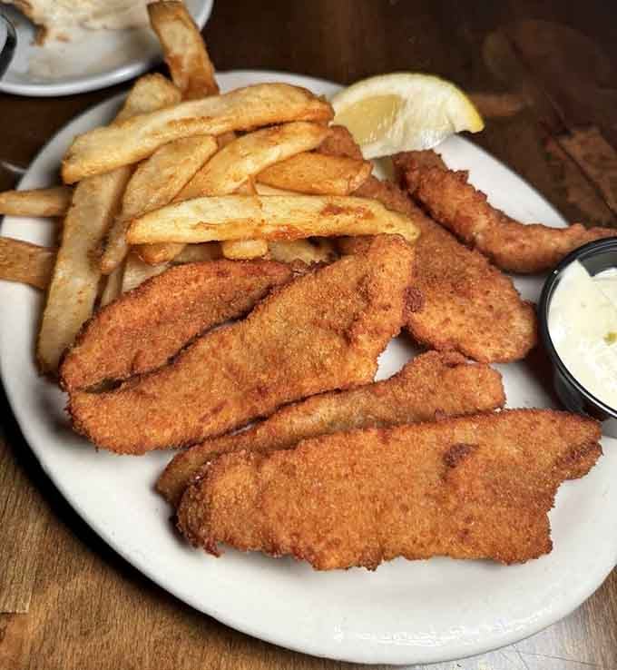 Golden fried lake perch with fries, proving that Wisconsin knows exactly what to do with freshwater fish and hot oil.