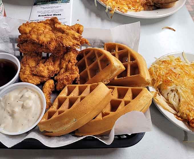Chicken and waffles unite in crispy, golden harmony, creating the kind of plate that makes breakfast-for-dinner completely acceptable.