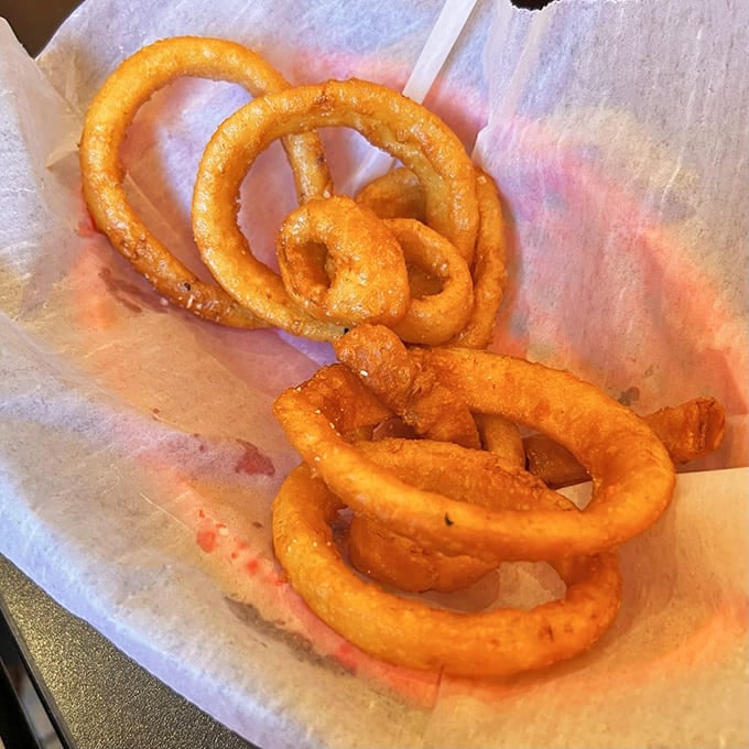 Onion rings with the structural integrity of Olympic gymnastics equipment. The perfect crunch that echoes through the restaurant.