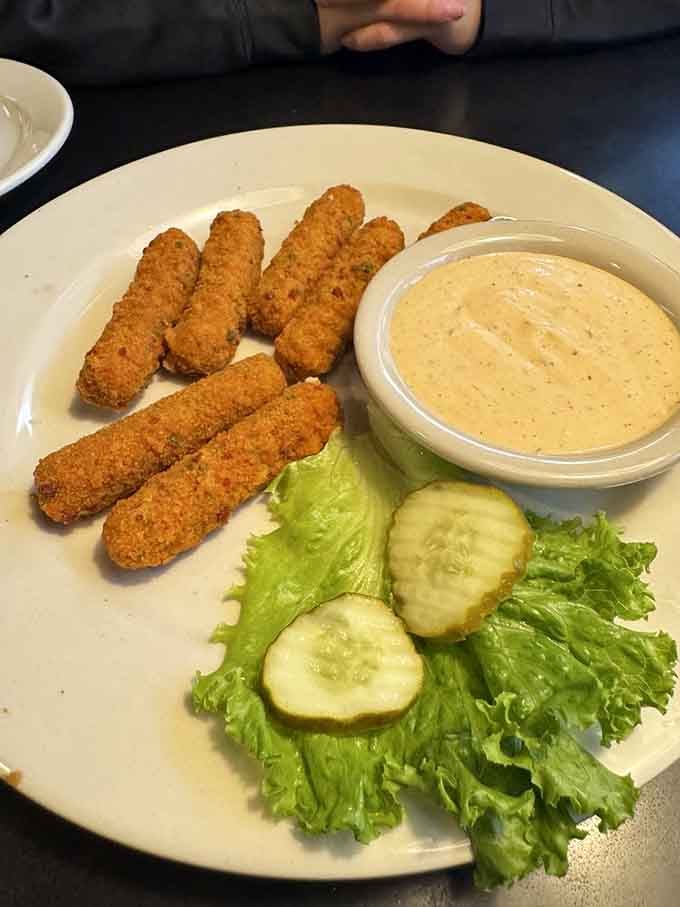 Crispy mozzarella sticks with dipping sauce offer the kind of comfort food that makes everything feel right again.