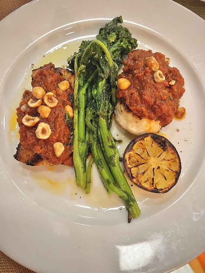 Swordfish arrives beautifully plated with vibrant accompaniments, proving this kitchen handles seafood as masterfully as their famous pizzas.