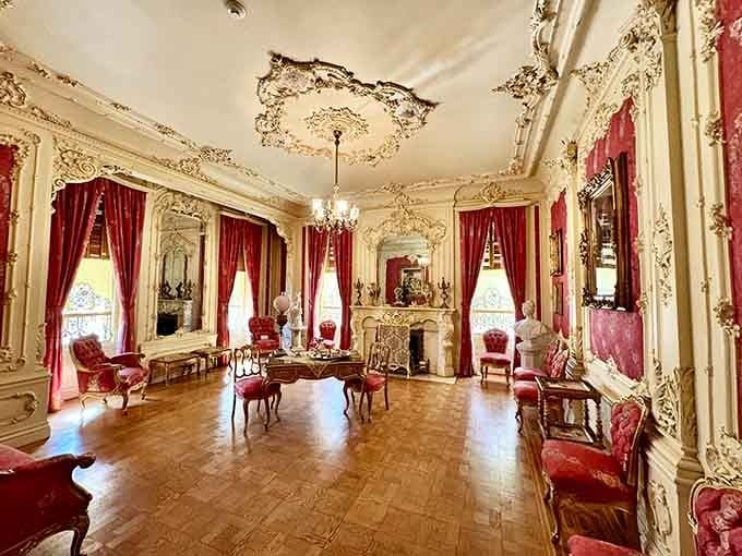Red velvet and ornate plasterwork creating a room where even casual conversations probably sounded like important declarations.