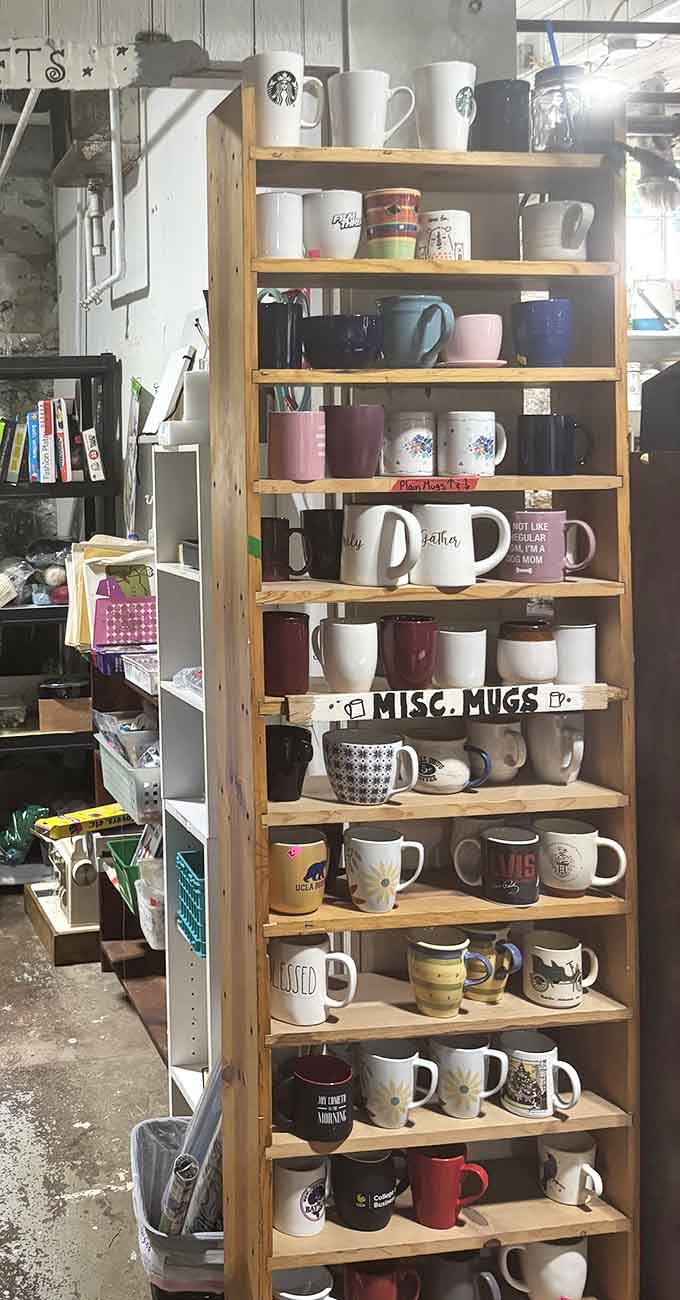 Coffee mugs lined up like a caffeinated rainbow, because apparently everyone needs a vessel that announces their personality each morning.