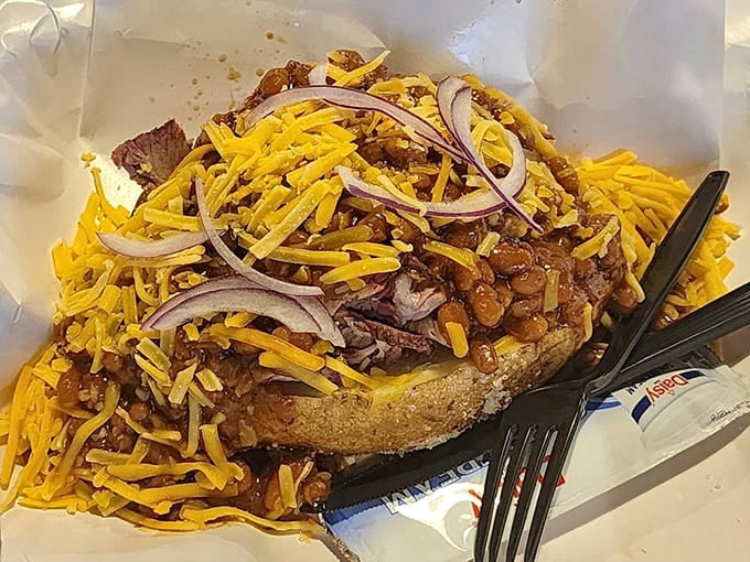 A baked potato becomes a vehicle for greatness when topped with brisket, beans, cheese, and onions galore.