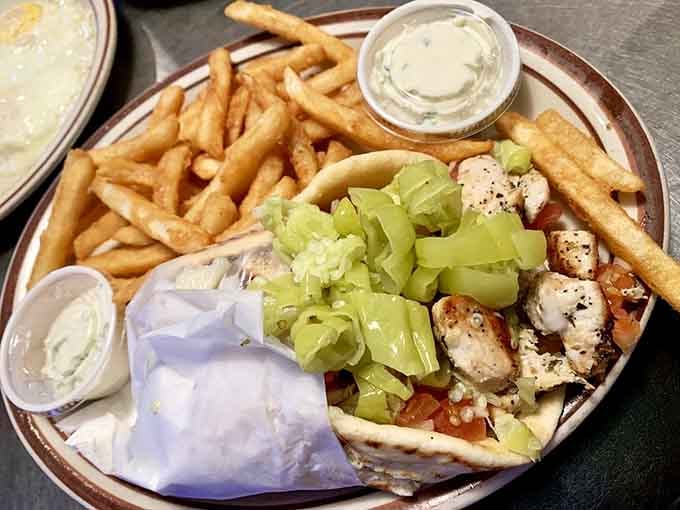 Chicken kabob sandwich served with pepperoncini, fries, and creamy tzatziki for dipping everything.