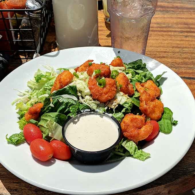 Buffalo shrimp transforms a simple salad into something worth writing home about, or at least texting your friends.