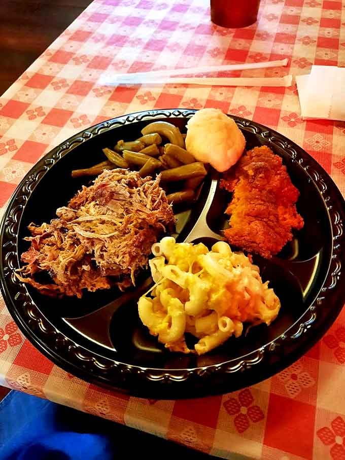 A black plate showcasing the holy trinity: pulled pork, mac and cheese, and green beans. This isn't just dinner &ndash; it's a religious experience.