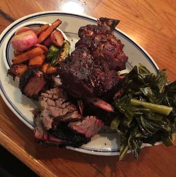 A barbecue platter loaded with ribs, brisket, and roasted vegetables proves more is definitely more here.