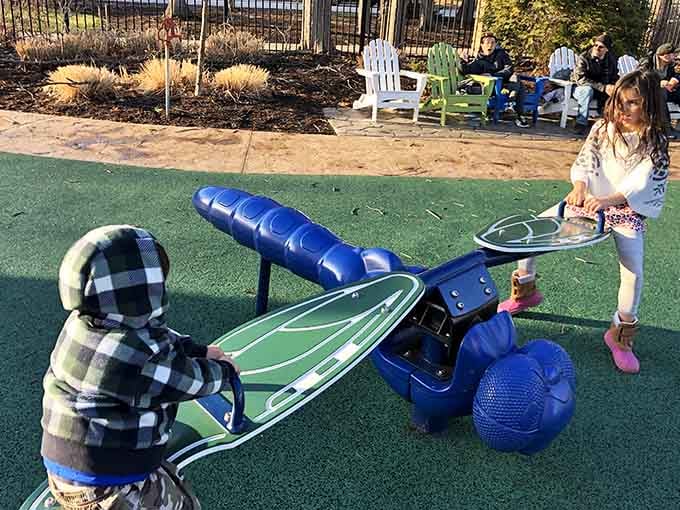 That blue seesaw creature looks like something from a whimsical children's book come to life.