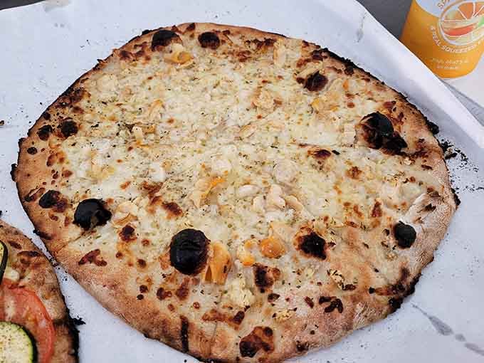 When you skip the tomato sauce, magic happens: garlic, cheese, and char in perfect harmony on every slice.