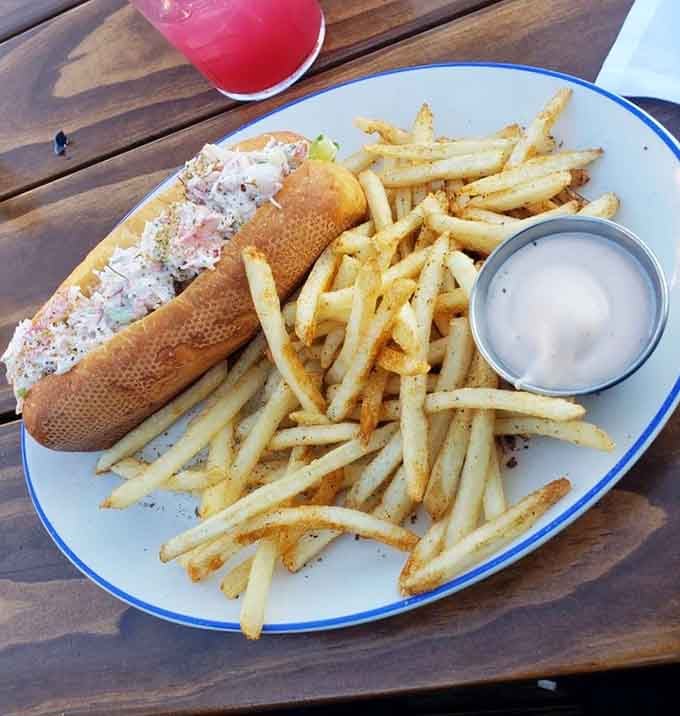 That gorgeous lobster roll overflowing with tender meat, flanked by golden fries, is what waterfront dining dreams are made of.