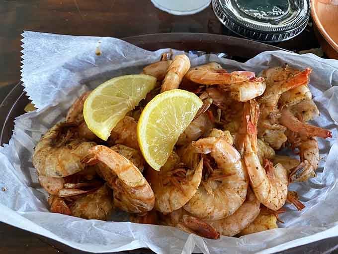 Perfectly fried shrimp with lemon wedges sitting in paper-lined baskets, looking exactly like your beach vacation dreams taste.