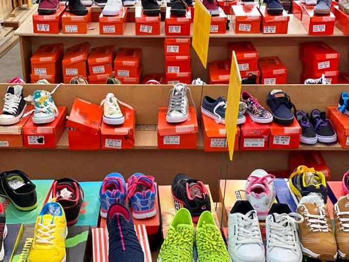 Sneakers in every color line the shelves, making footwear shopping feel like a rainbow exploded in the best possible way.