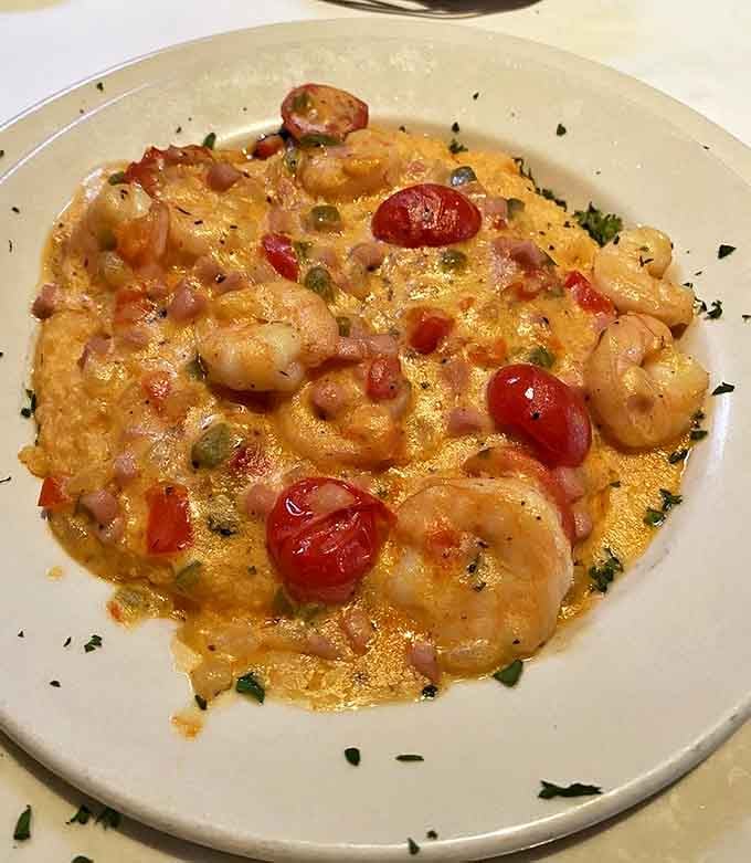 Shrimp and grits elevated to an art form&mdash;creamy, cheesy goodness studded with plump Gulf shrimp and brightened with fresh tomatoes and herbs.