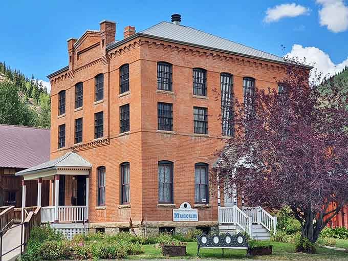 Brick walls and iron-barred windows tell stories of the past as you explore this historic museum nestled against the mountains.