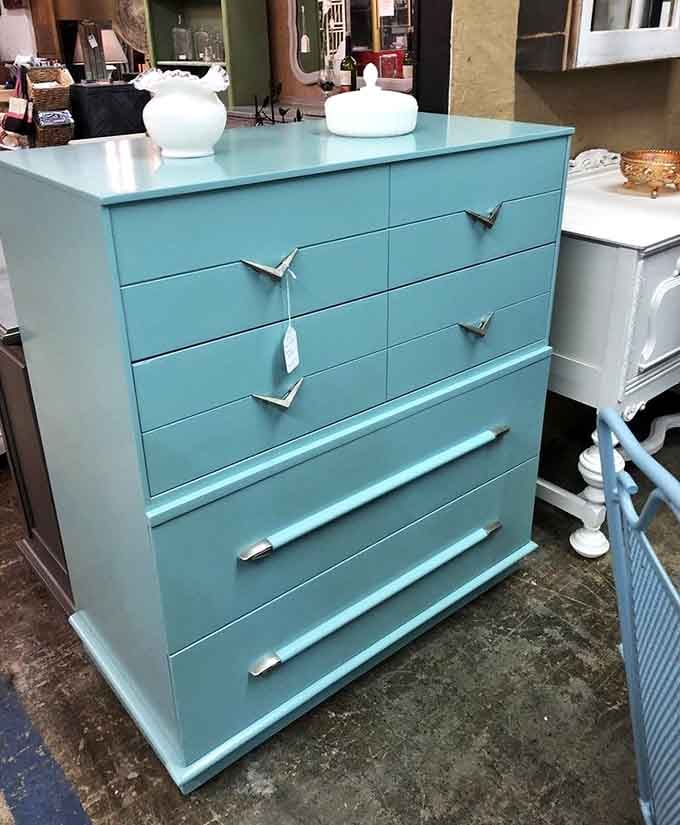 That turquoise dresser with boomerang handles screams 1950s sophistication louder than a Sinatra record on Saturday night.