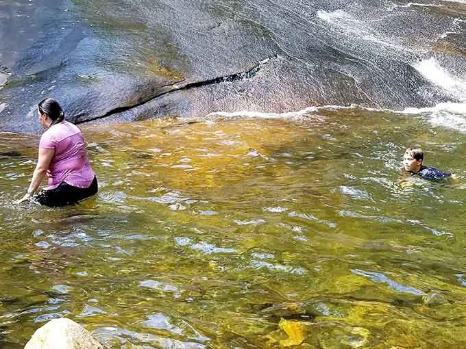 The pool at the bottom becomes a gathering place where strangers bond over shared cold-water courage.