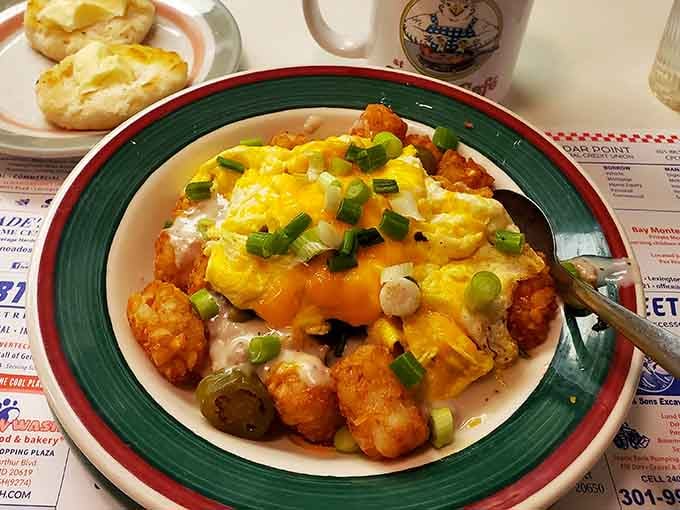 Breakfast nirvana achieved! This tater tot masterpiece crowned with melted cheese, eggs, and green onions is what breakfast dreams are made of&mdash;comfort food elevated to an art form.