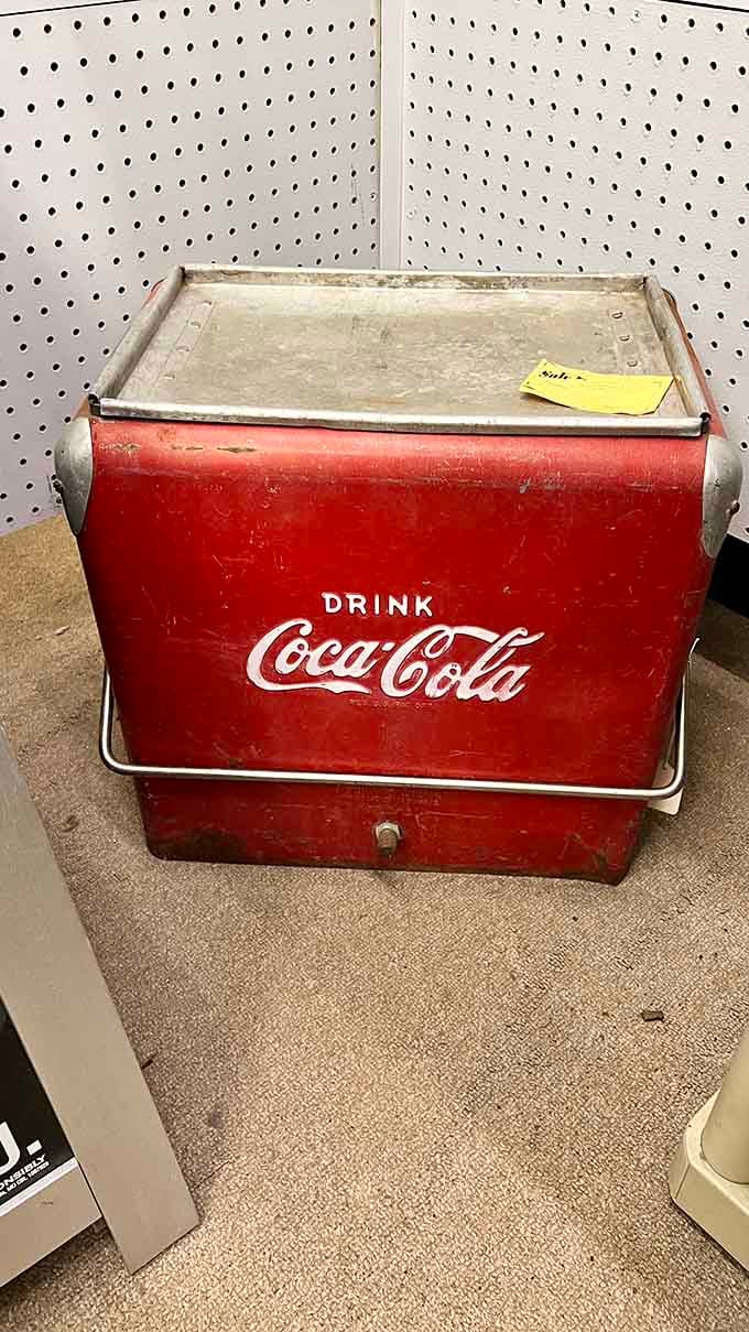 This weathered Coca-Cola cooler once kept sodas ice-cold at picnics when summer lasted forever.