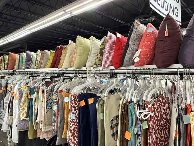 Pillows stacked like a textile tower of Babel, each one whispering promises of cozy afternoons ahead.