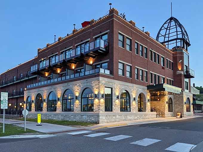 Evening lights illuminate stone arches that frame modern comfort within historic walls, blending eras with remarkable grace and style.