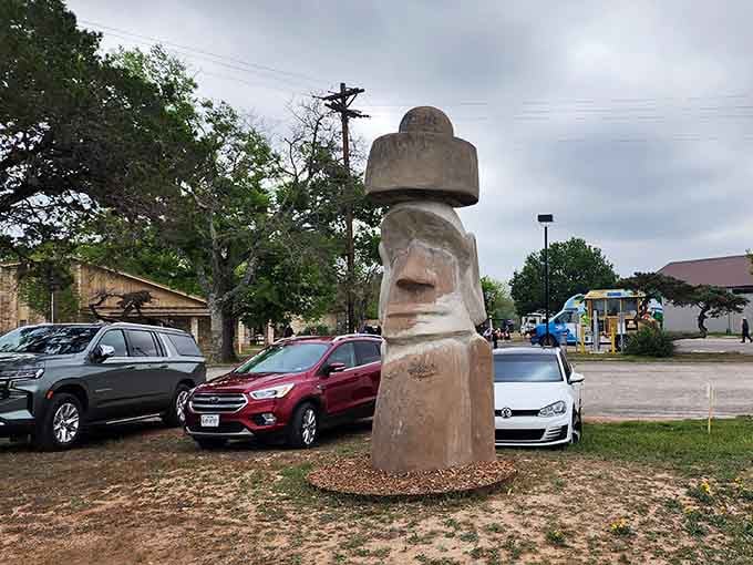 The moai keeps watch over arriving guests, silently judging your parking job with that iconic Easter Island stare.