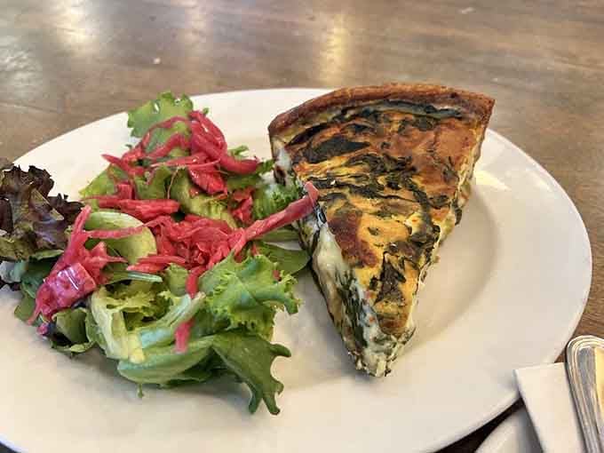 Flaky pastry cradling savory filling alongside fresh greens makes lunch feel like a proper European midday meal.