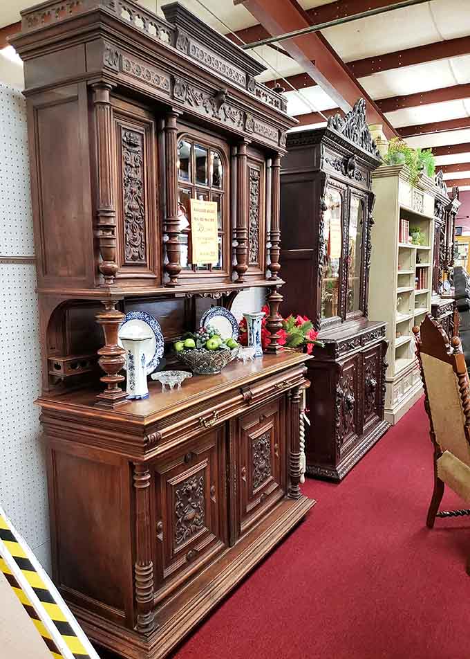 Ornate carved hutches tower overhead like wooden cathedrals, making you question every IKEA purchase you've ever justified to yourself and others.