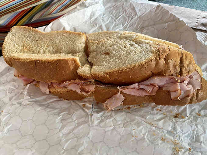 Baked ham piled high on fresh bread, proving that simple ingredients done right beat complicated any day.